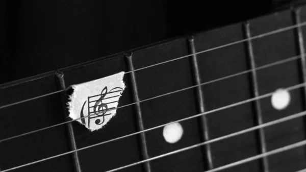 Guitar strings and torn paper notes, music - Stock Image - Everypixel