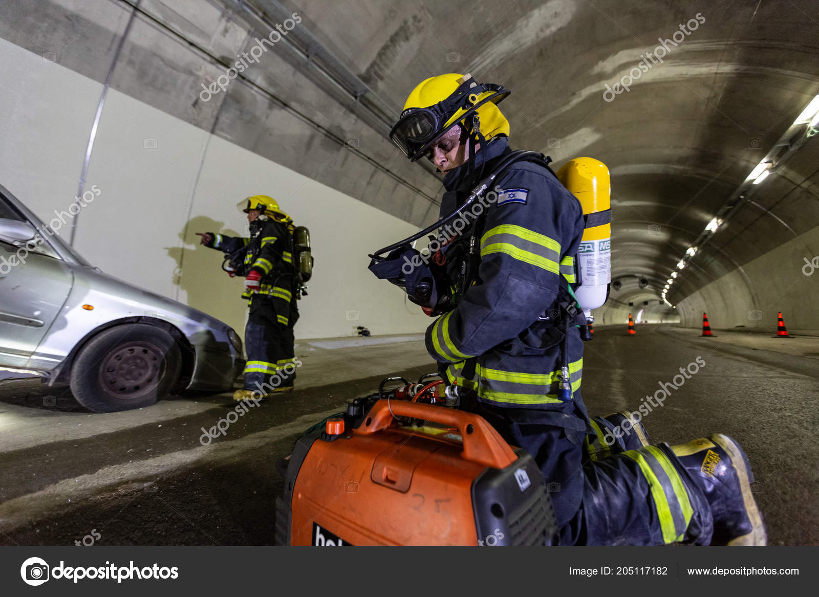 Car accident scene inside a tunnel, firefighters rescuing people from ...