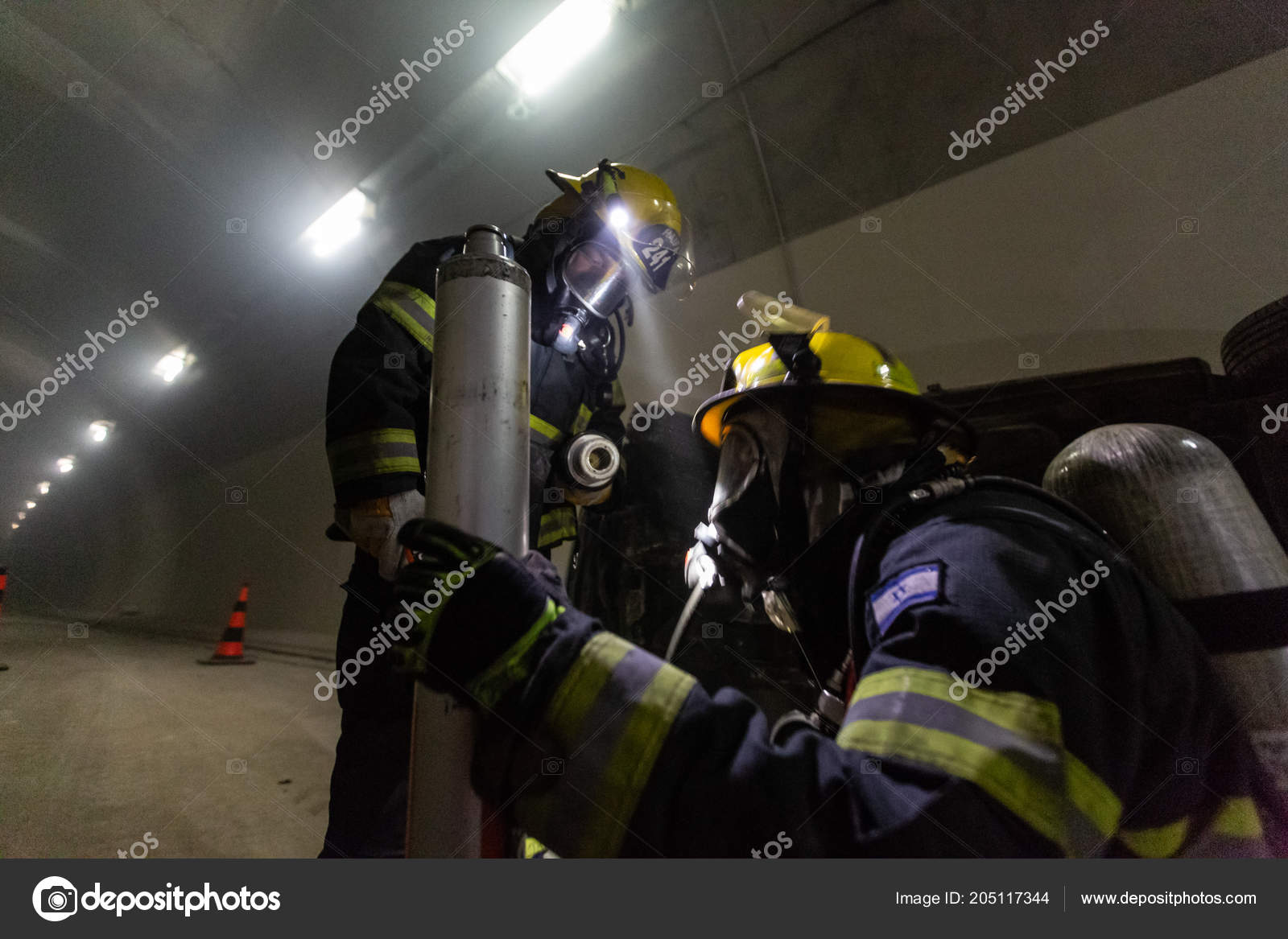 Car accident scene inside a tunnel, firefighters rescuing people from ...