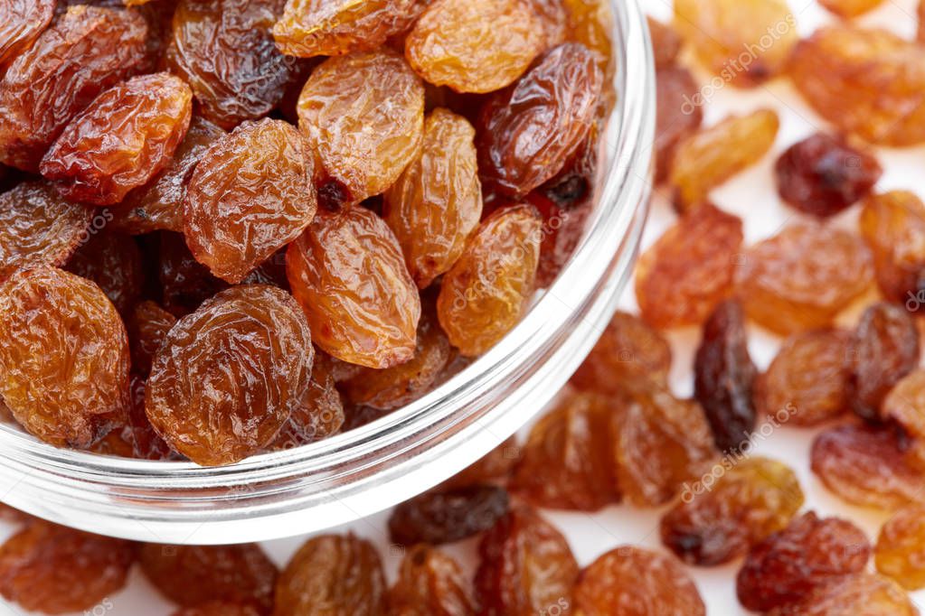 tazón de pasas sobre un fondo blanco. Uvas secas. 2022