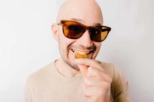 Closeup portrait of male licking and biting roasted sausage with ...