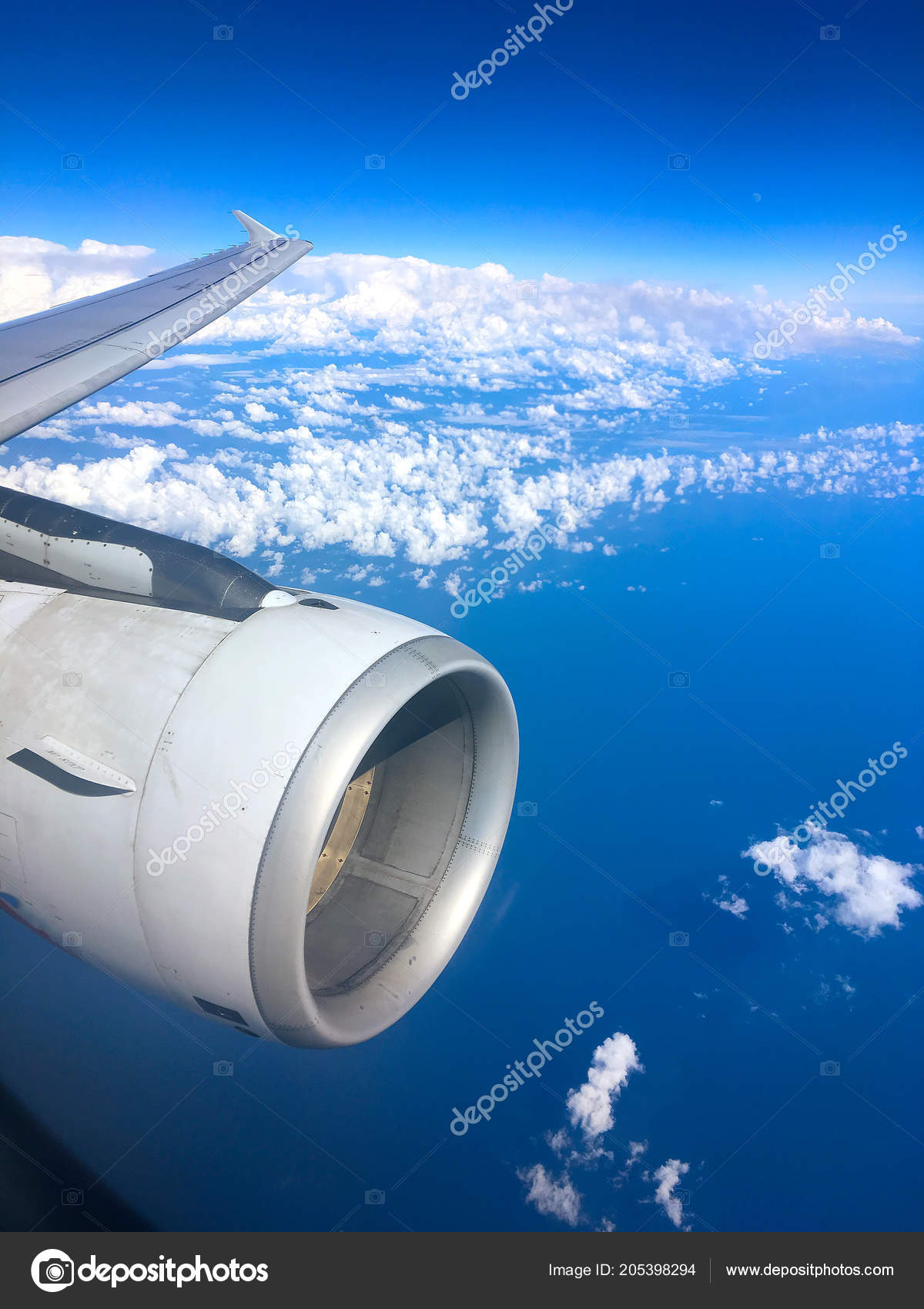 Passenger view through the window of a jet plane showing sky, clouds ...