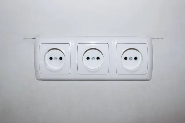 Three White Sockets On The White Wall . Work Area In The Room. Repairs ...