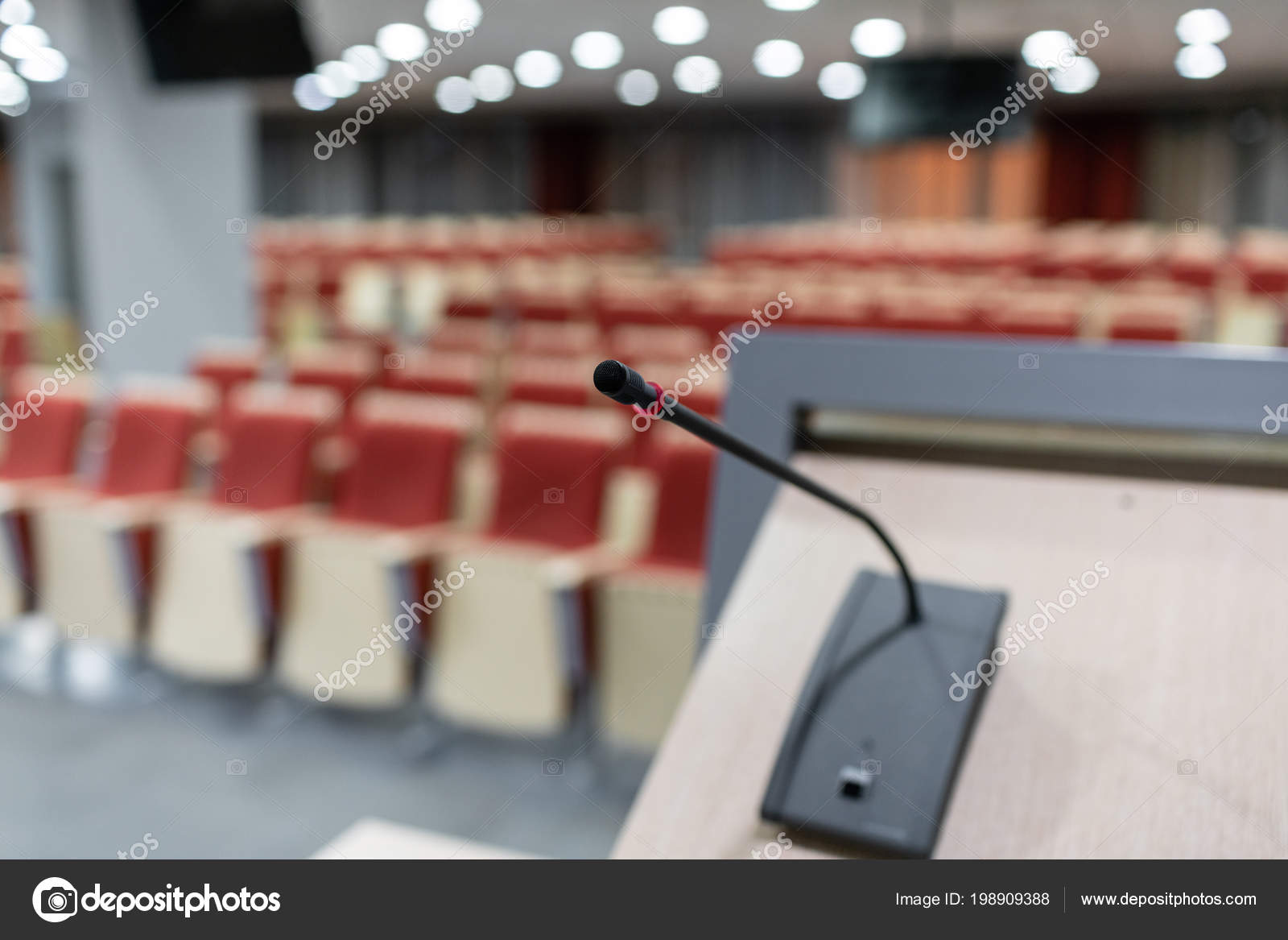 Microphone in the foreground. Seminar presentation. Conference room ...
