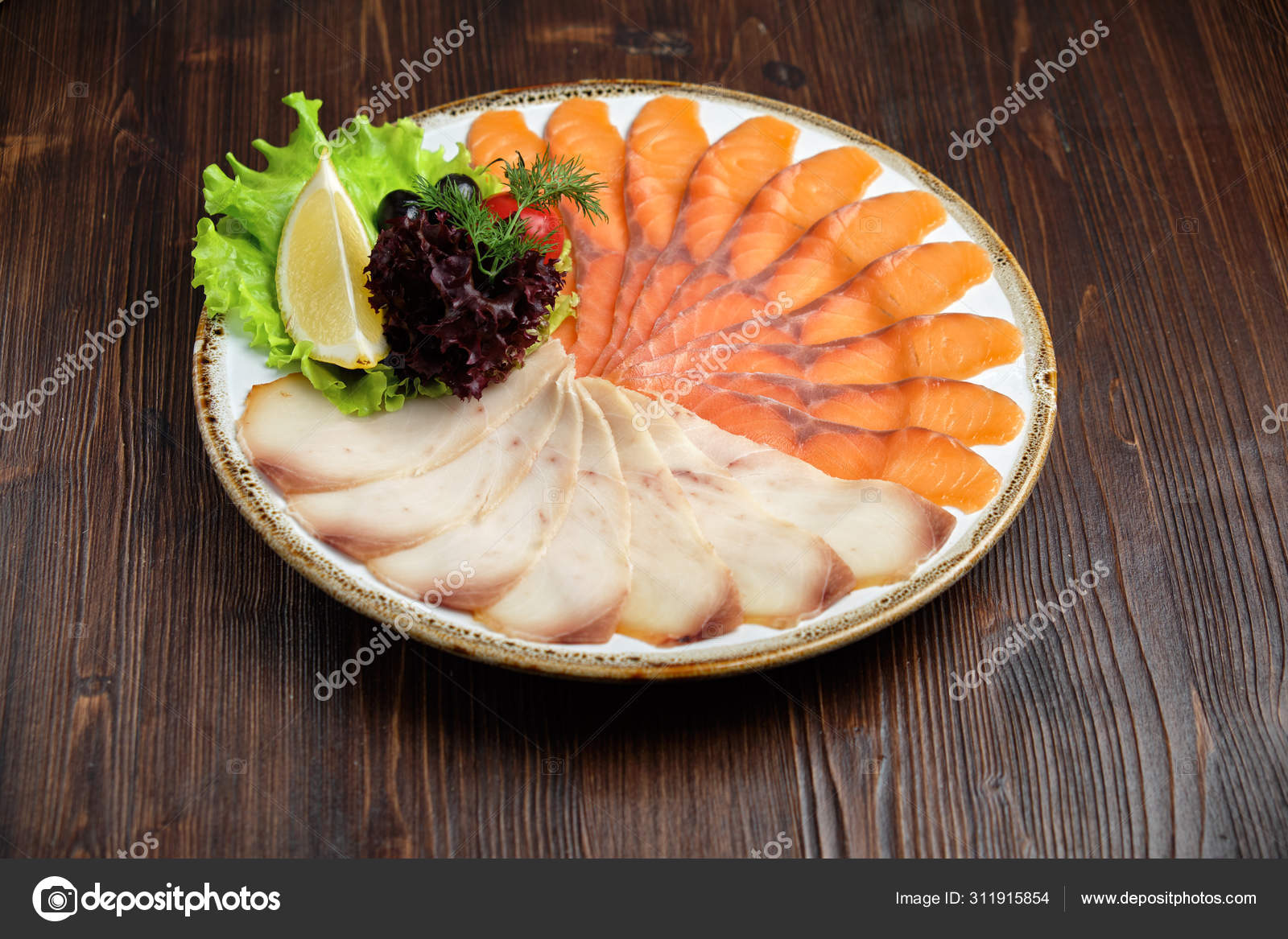 White and red fish sliced in thin slices on a brown wooden background ...