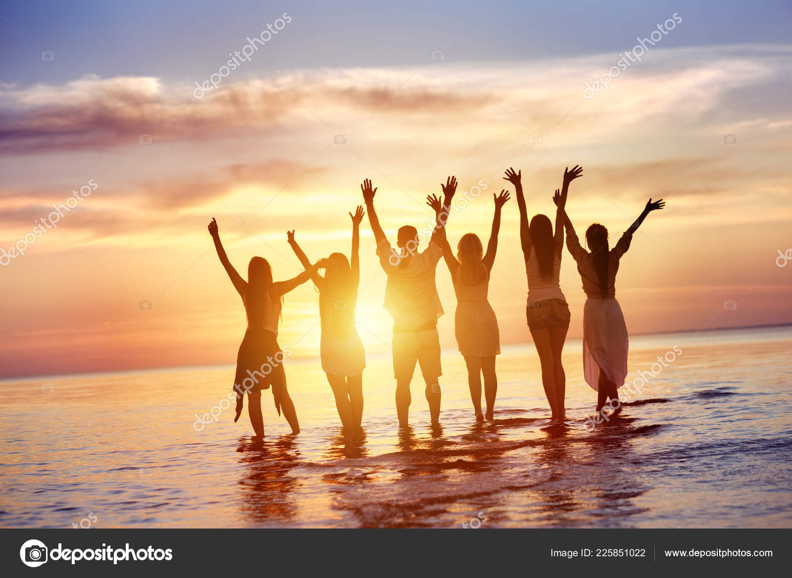 Happy friends look at sunset over the water — Stock Photo © cppzone ...