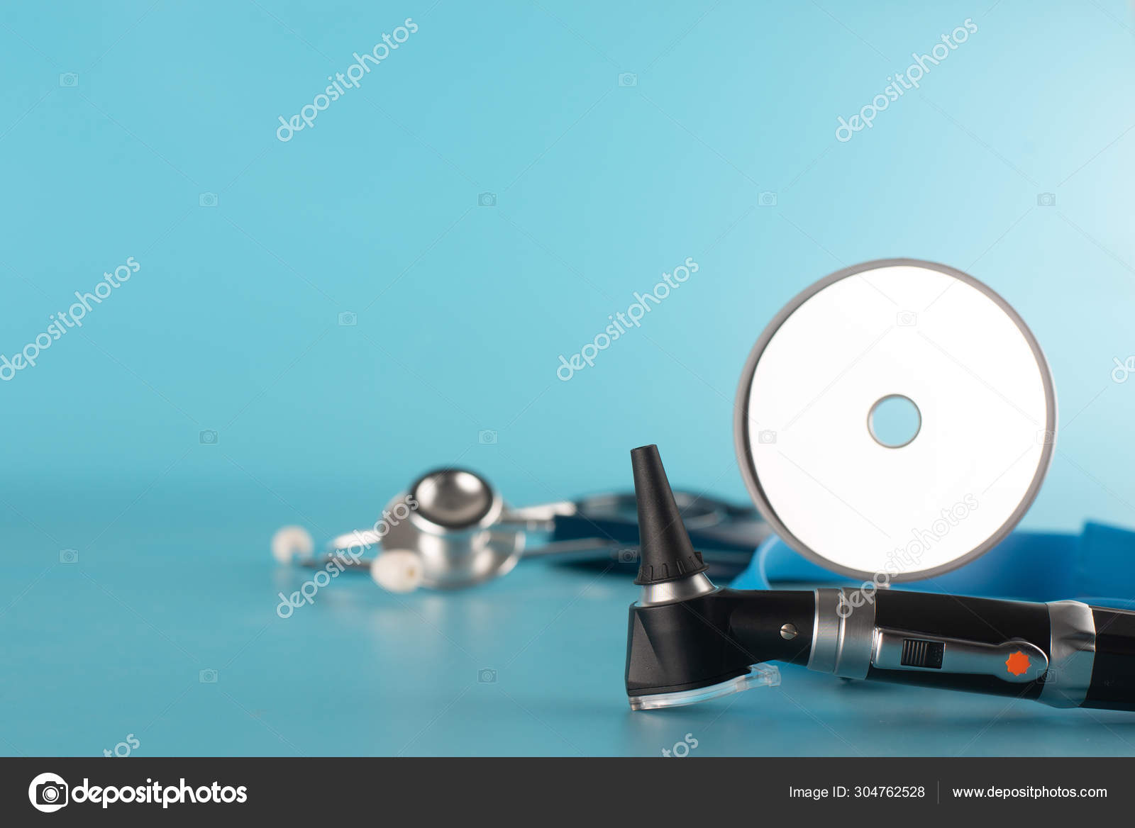Otoscope with stethoscope and reflector mirror on blue backgroun Stock ...