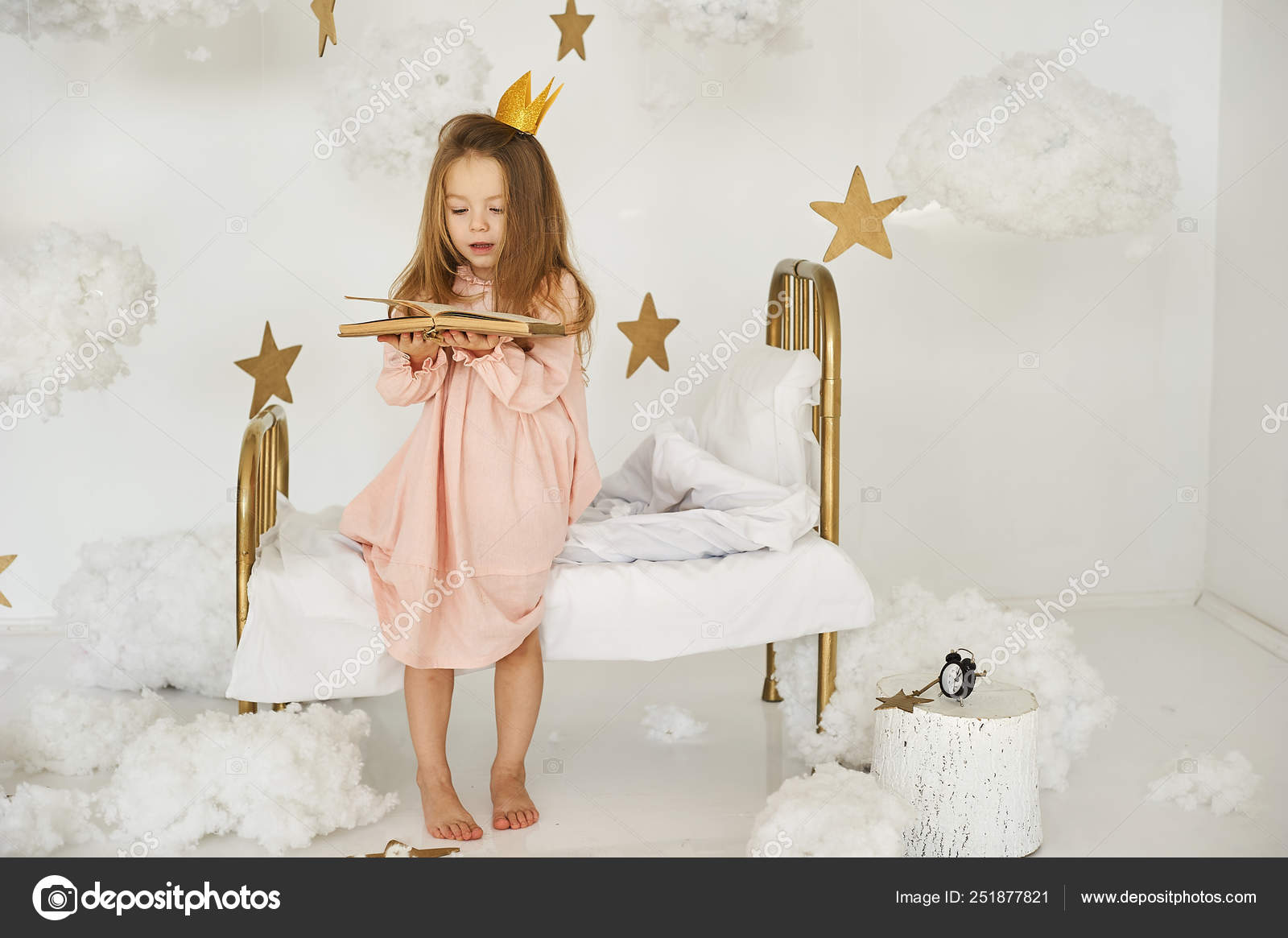 Little princess with a magic wand on bed in a cloud Stock Photo by ...