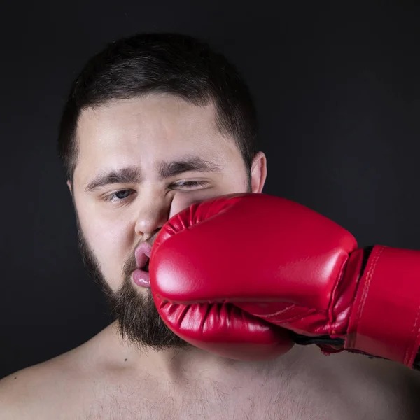 Boxer in red gloves for boxing strikes the opponent to the man. A man ...