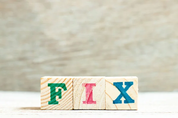 Alphabet letter in word fix on wood background - Stock Image - Everypixel