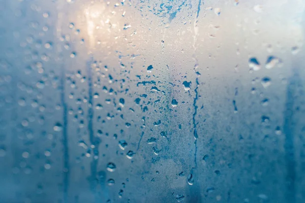 Strong humidity in wintertime. Water drops from home condensation on a ...