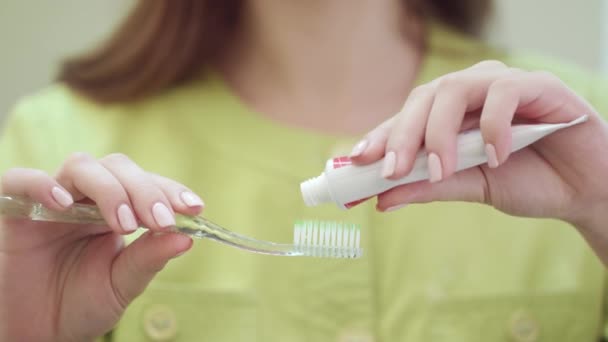 Doctor hands squeezing toothpaste on toothbrush. Morning teeth care ...