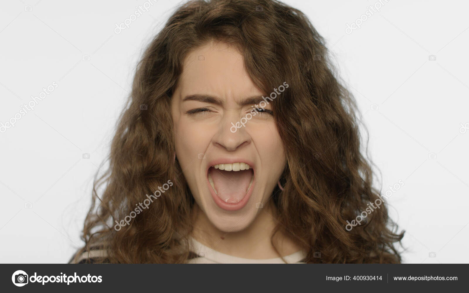 Angry woman screaming in studio. Portrait of rage girl scream on white ...