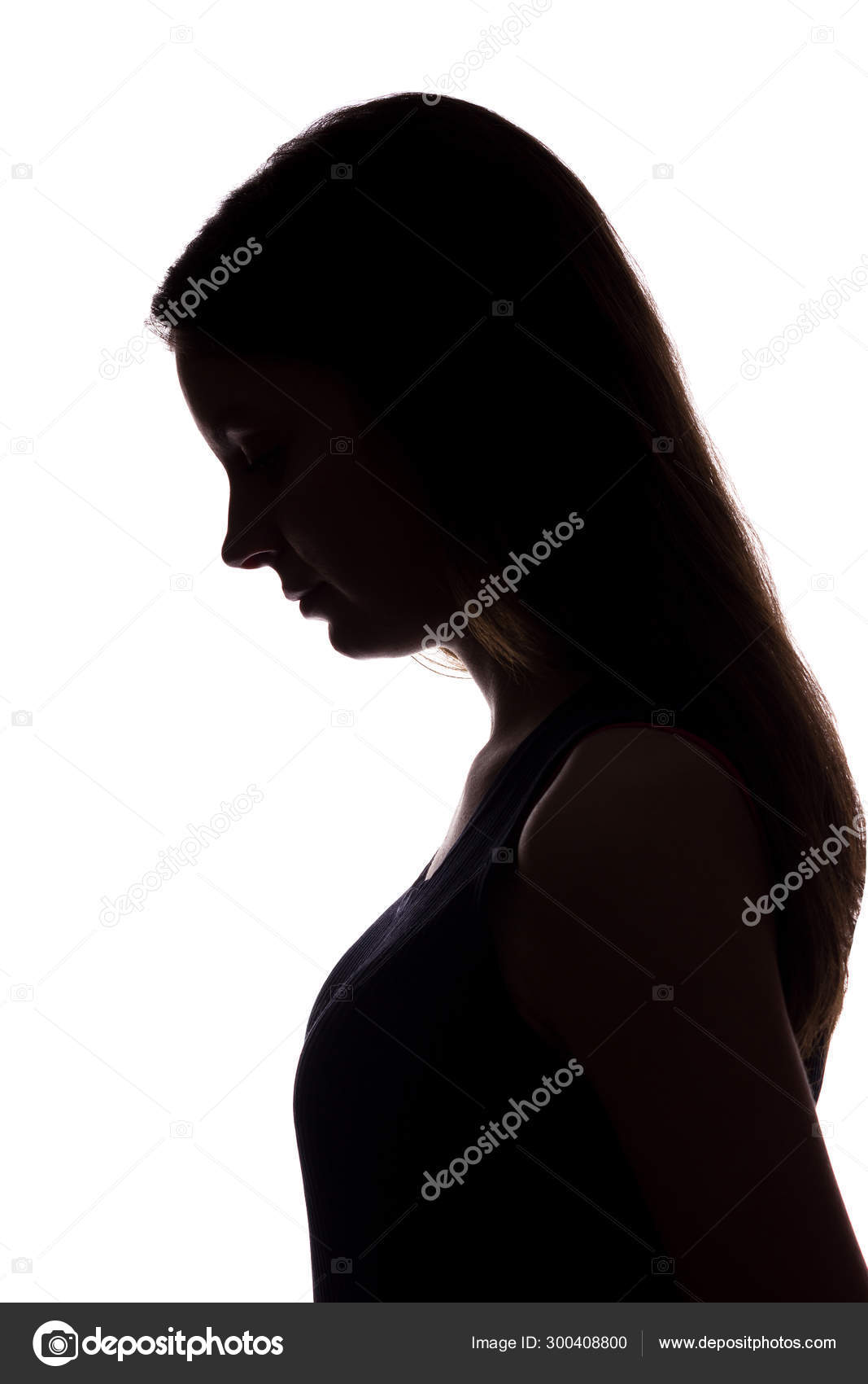 Young woman look down with flowing hair - vertical silhouette Stock ...