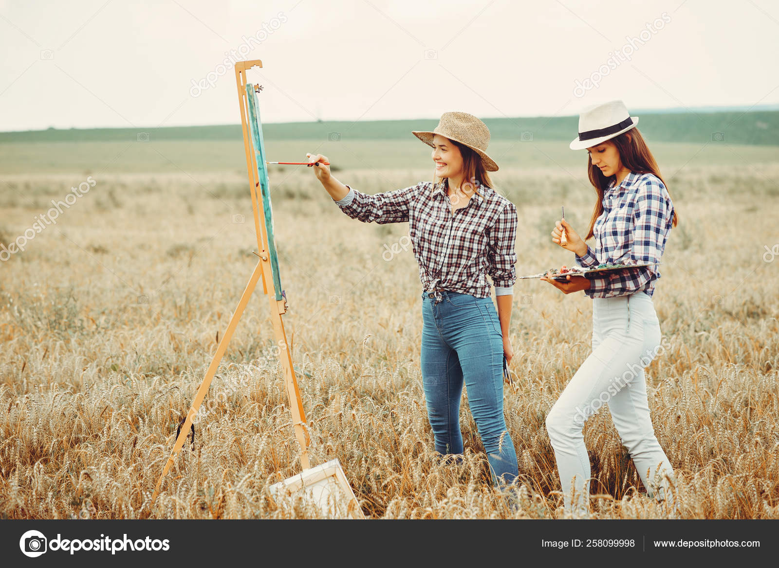 Two beautiful girls drawing in a field — Stock Photo © hetmanstock ...