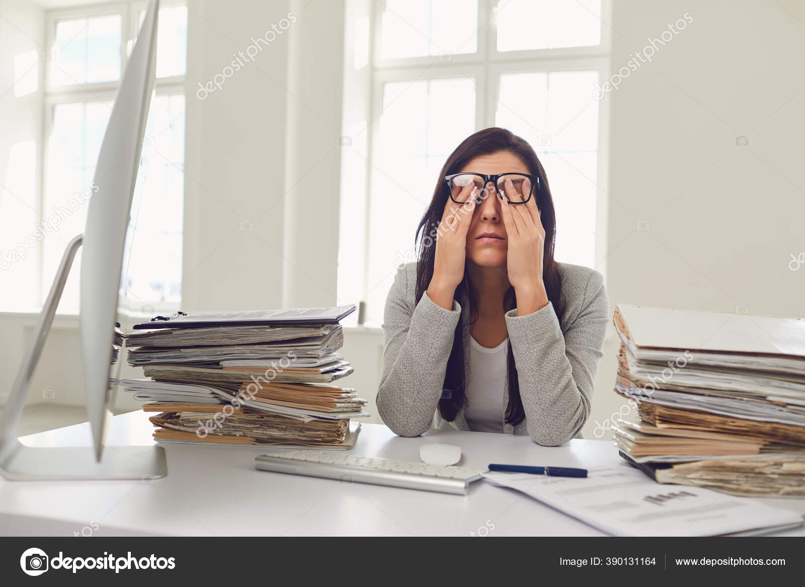 A lot of work in the office. Tired busy businesswoman is working with ...