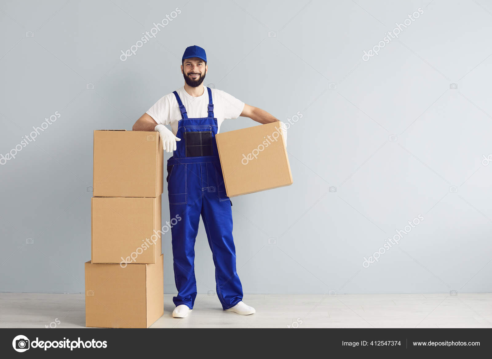 Happy delivery man with boxes Stock Photo by ©lacheev 412547374