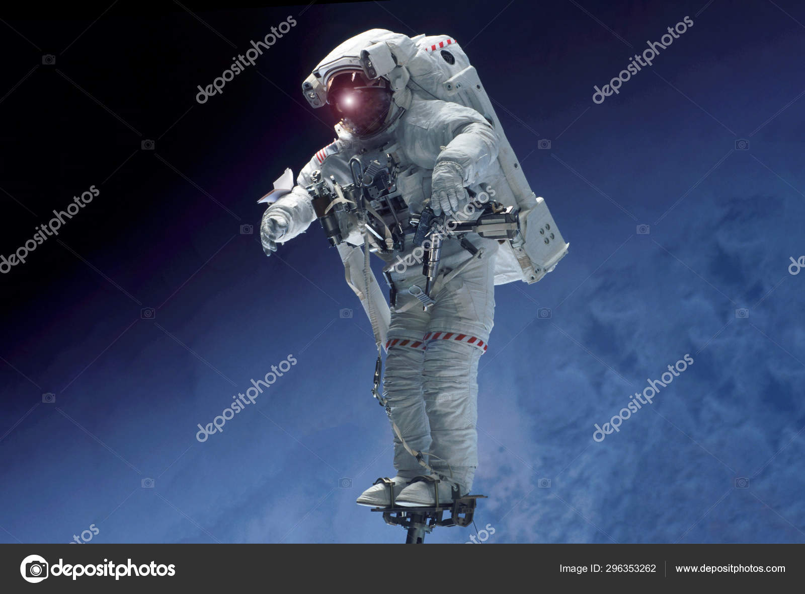 An astronaut in outer space, stands on a platform that holds his legs ...