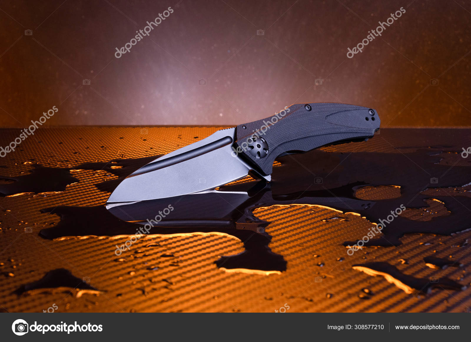 A knife on a table with water. Knife in spilled water. Drips of water ...