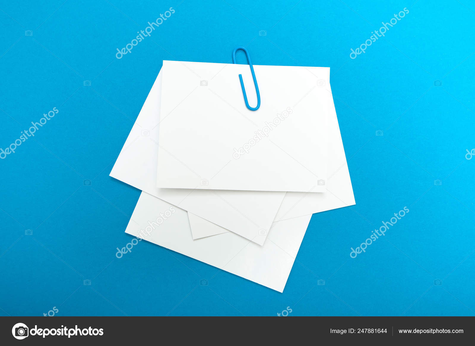 A set of a memorable paper note connected by a paper clip on a b ...