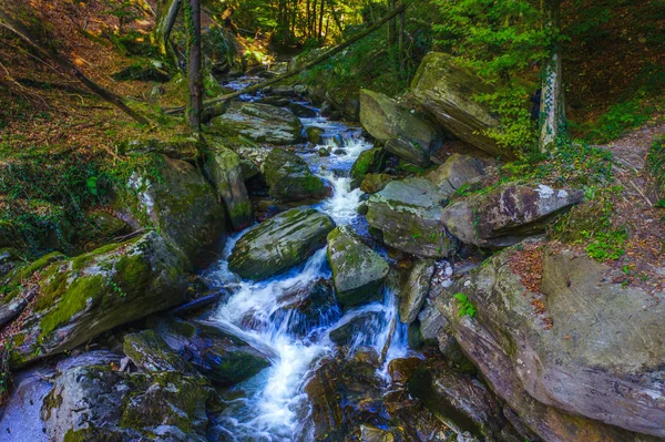 Mountain river flowing over rocks and boulders in forest - Stock Image ...