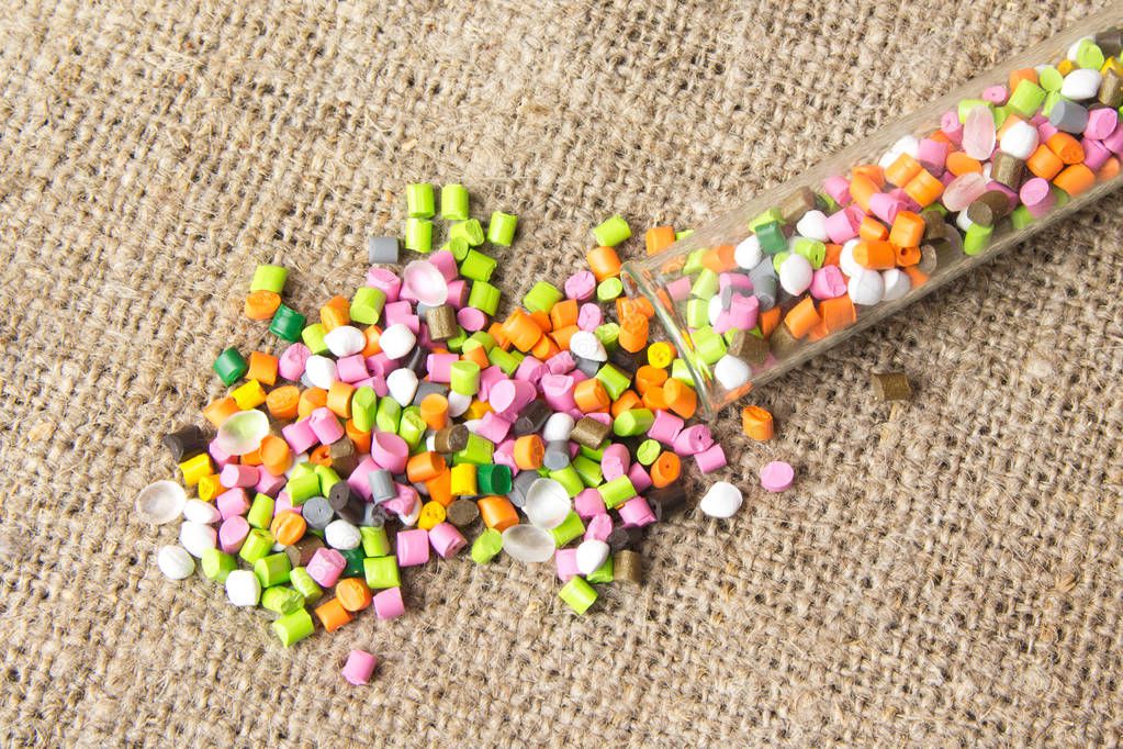 Pellets de plástico. Tinte polimérico en tubos de ensayo sobre fondo ...