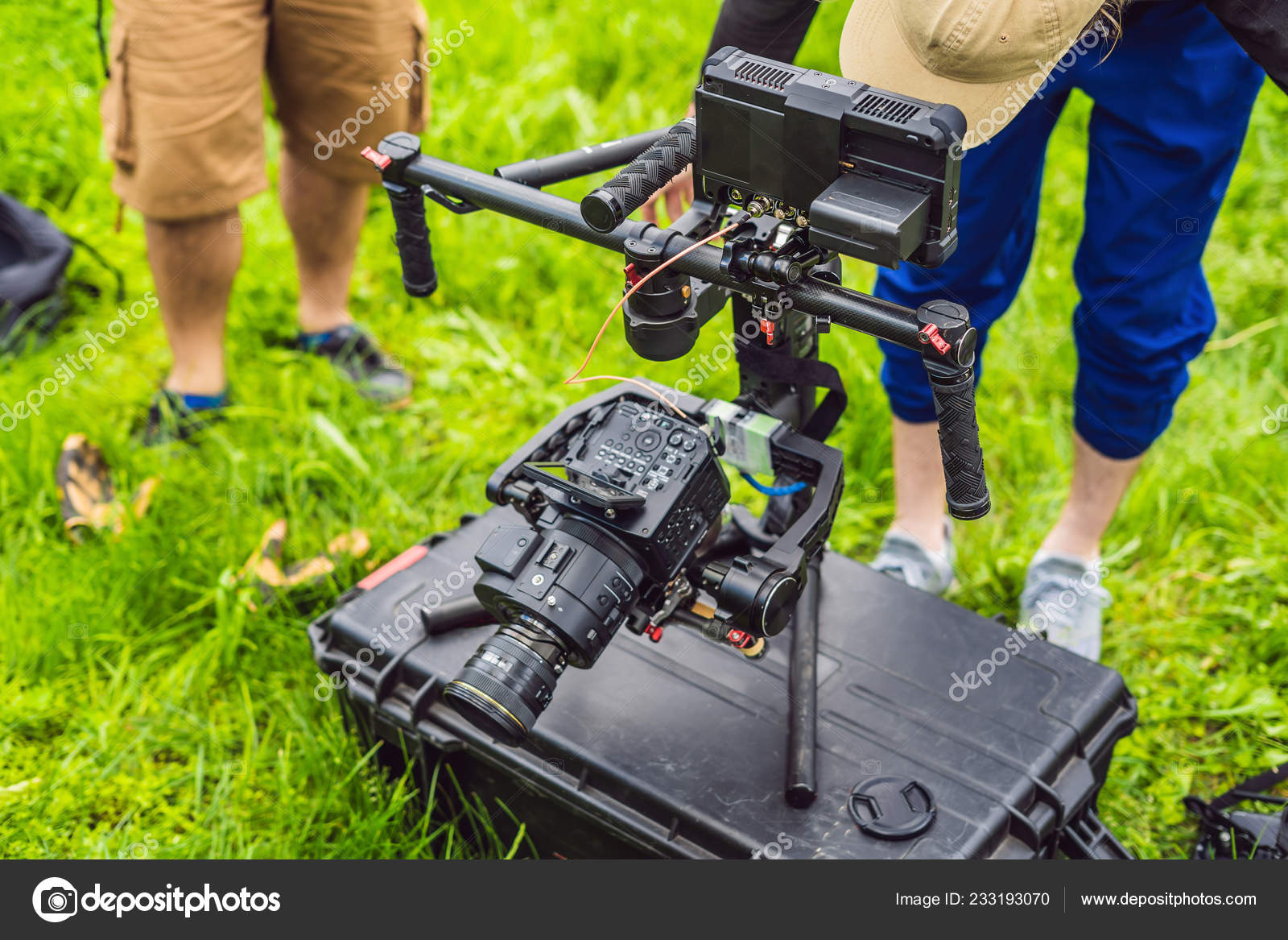 Cameraman setting up heavy duty professional 3-axis gimbal stabilizer ...