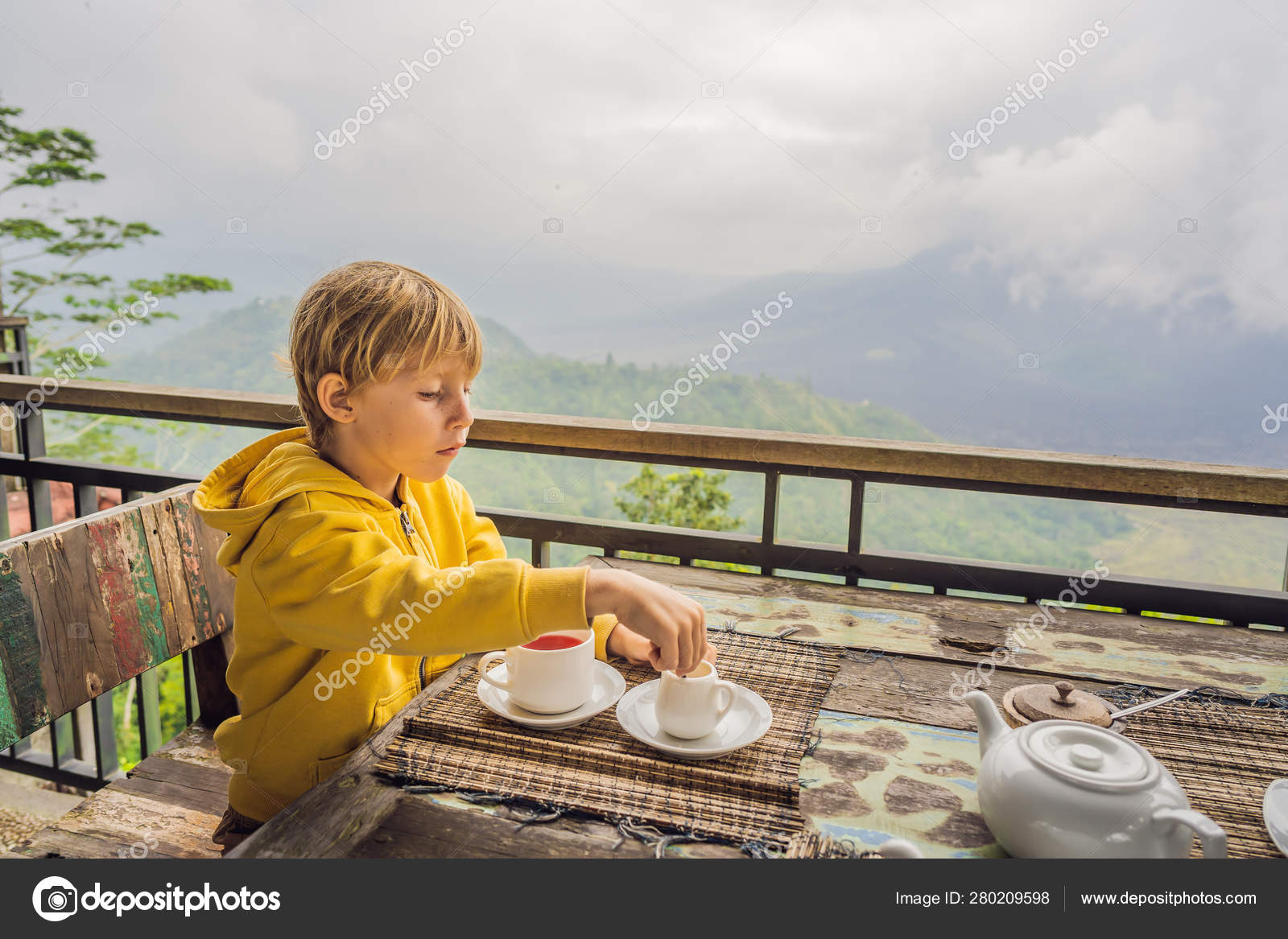Boy drinking tea in a cafe in the mountains Stock Photo by ©galitskaya ...