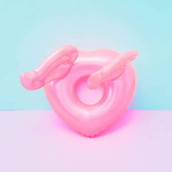 Inflatable pool toy in shape of heart with wings on pastel pink and ...