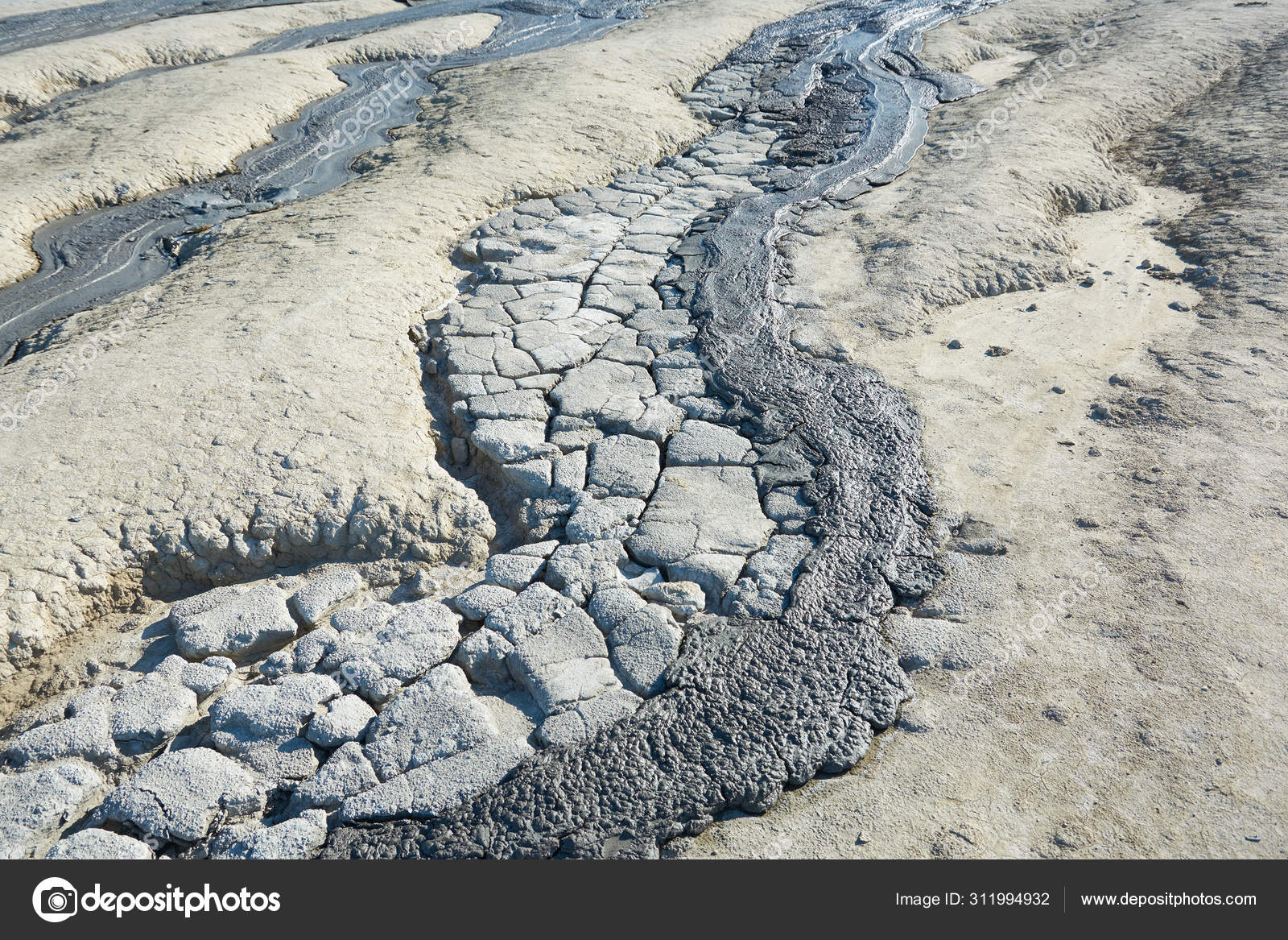 Mud flow from a mud volcano. Cracked mud surface. Mudflow texture with ...