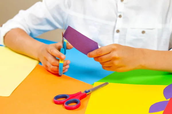 Kid folding colored paper and making origami. — Stock Photo © Vejaa ...