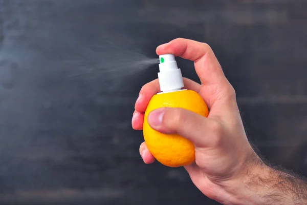Man sprinkles juice from lemon with help of pump for spray. Healthy ...