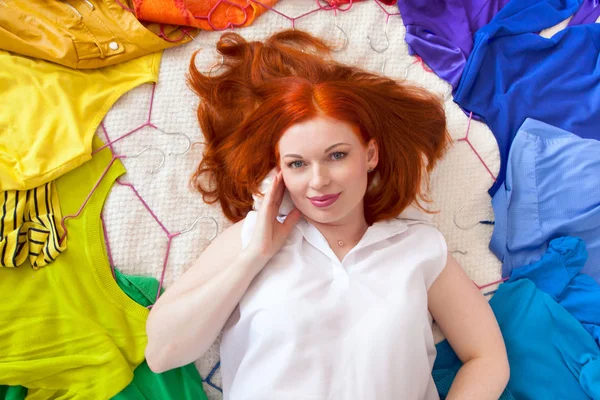 A circle of clothes of all colors of the rainbow. Different clothes lie ...