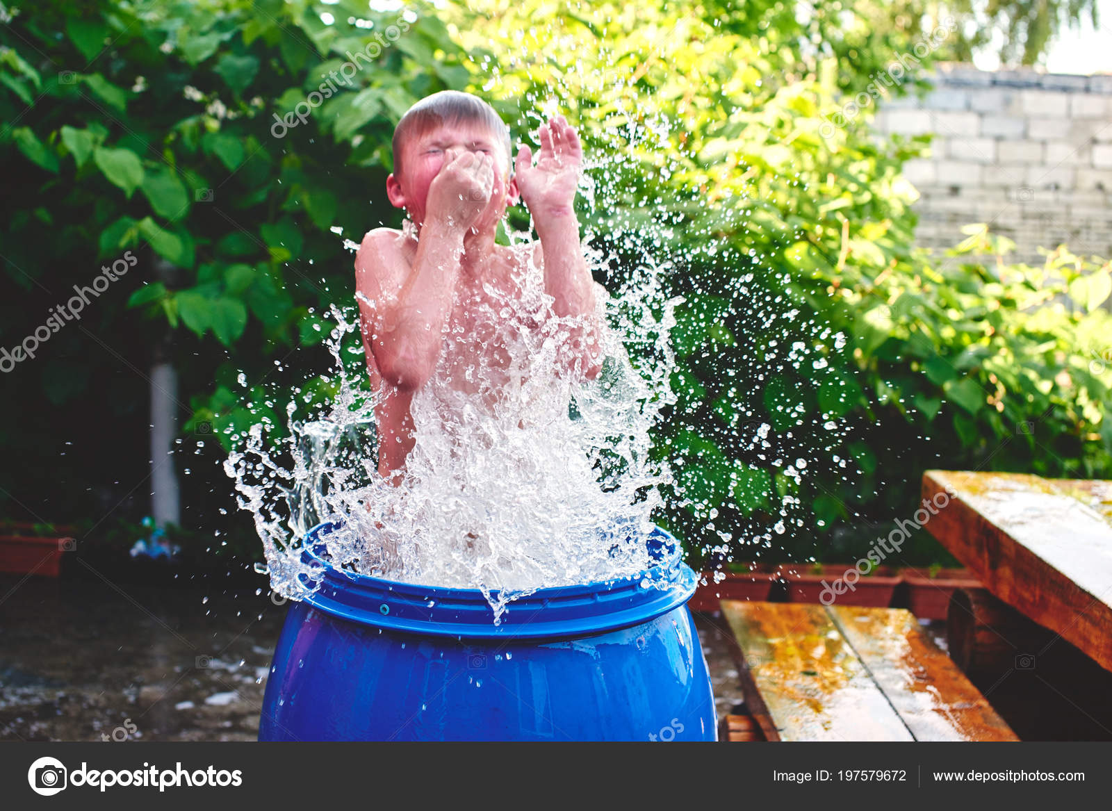 Boy Emerging Water Splashing Blue Barrel Courtyard Stock Photo by ...