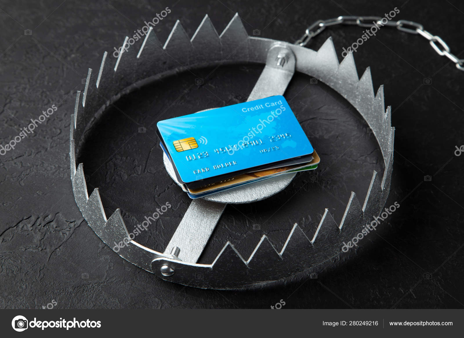 Trap with stack of credit cards. Unsafe credit risk. Black background ...