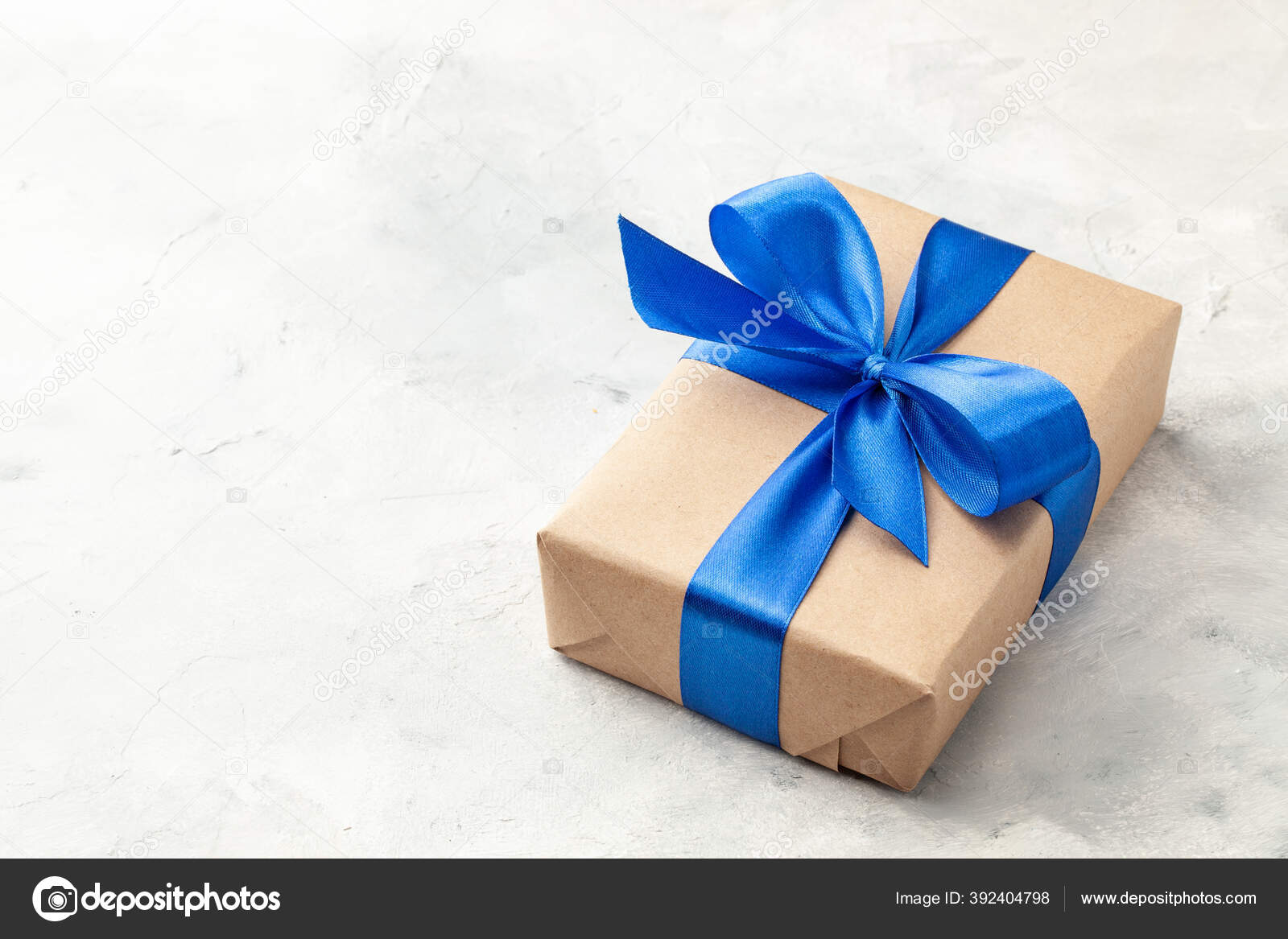 Gift with a blue ribbon on a gray background. — Stock Photo © ADragan ...