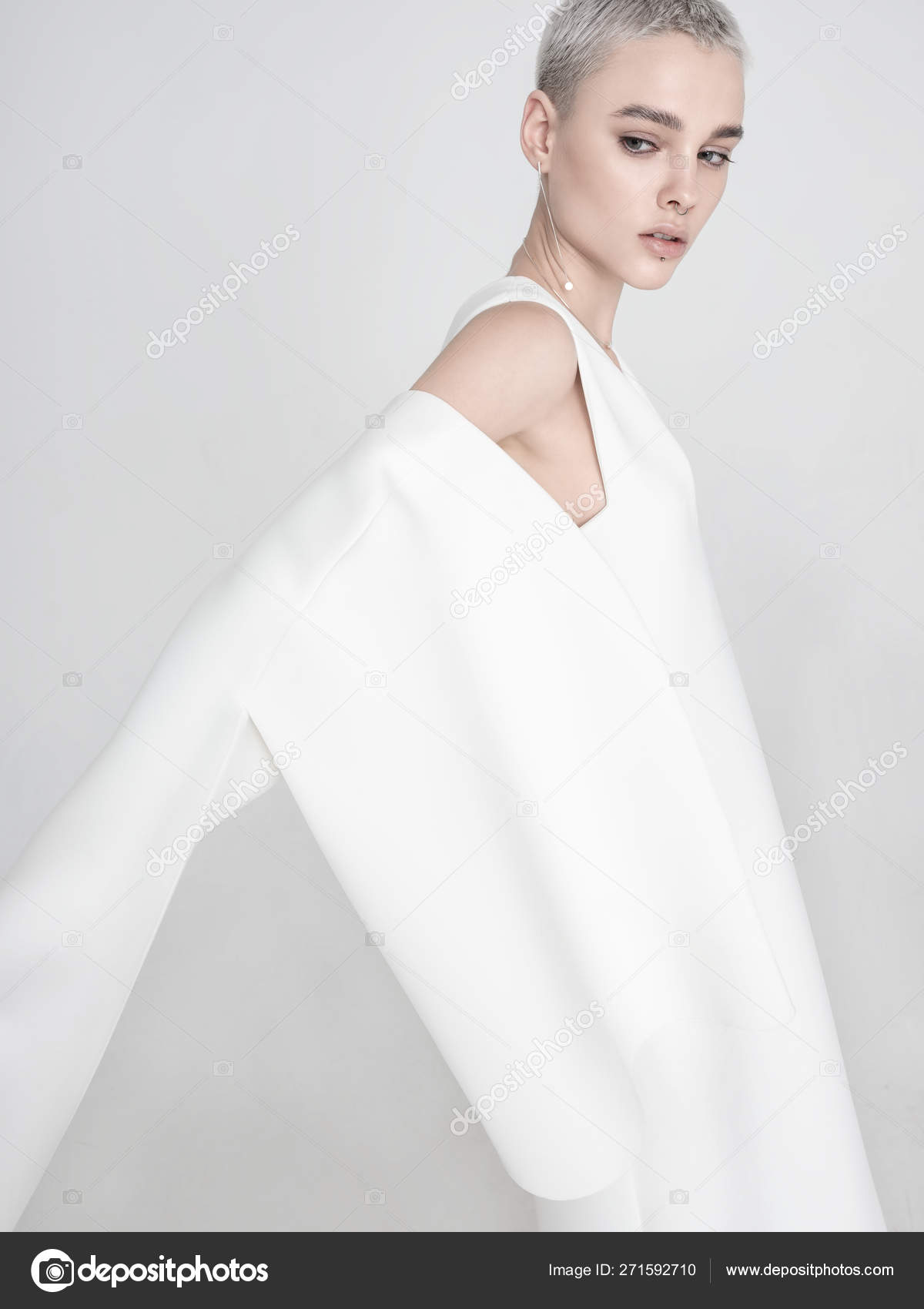 Trendy woman putting on jacket Stock Photo by ©quantiumpix 271592710