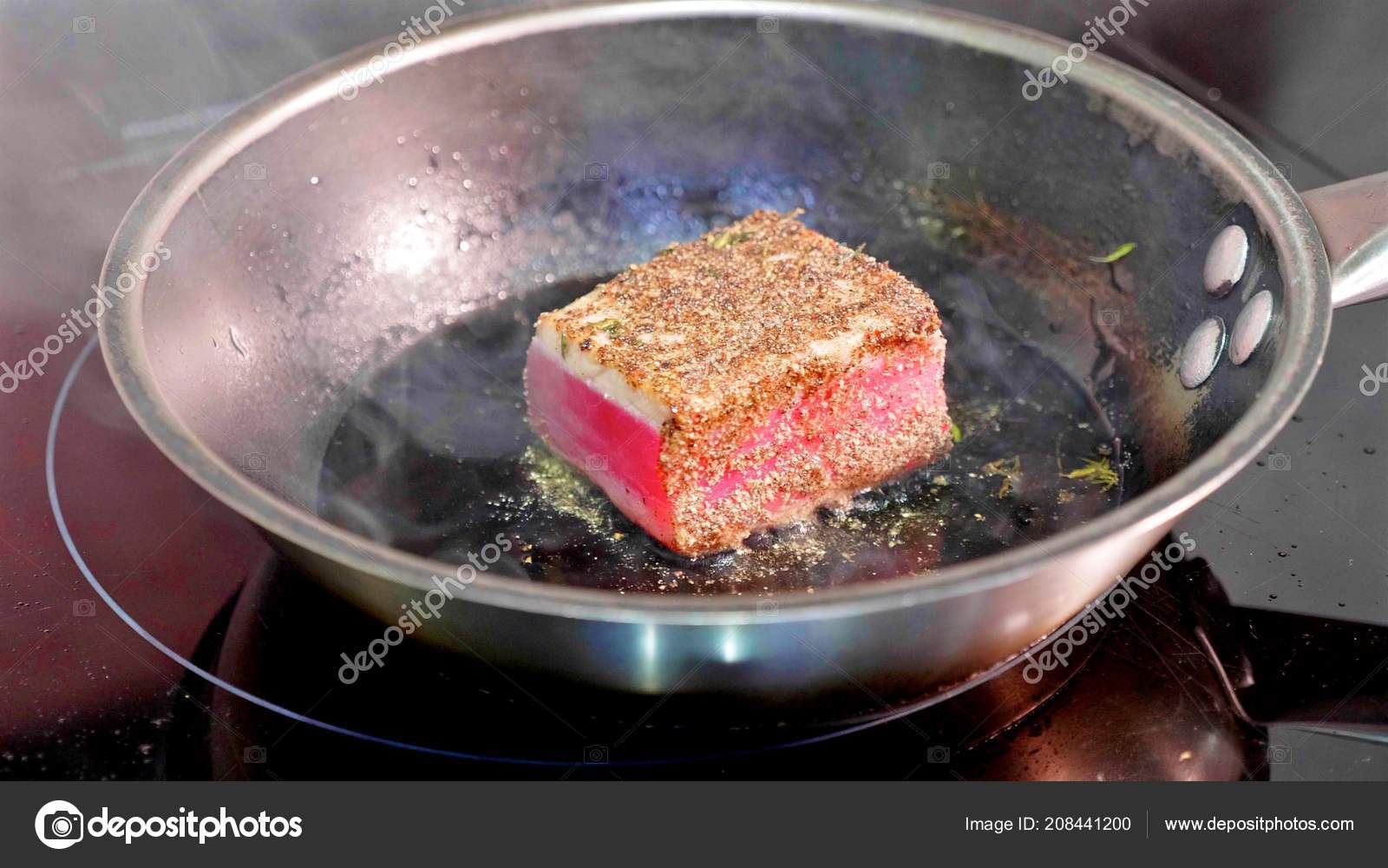 Pan-fried fish, The marlin fillet on the steaming frying pan. Stock ...