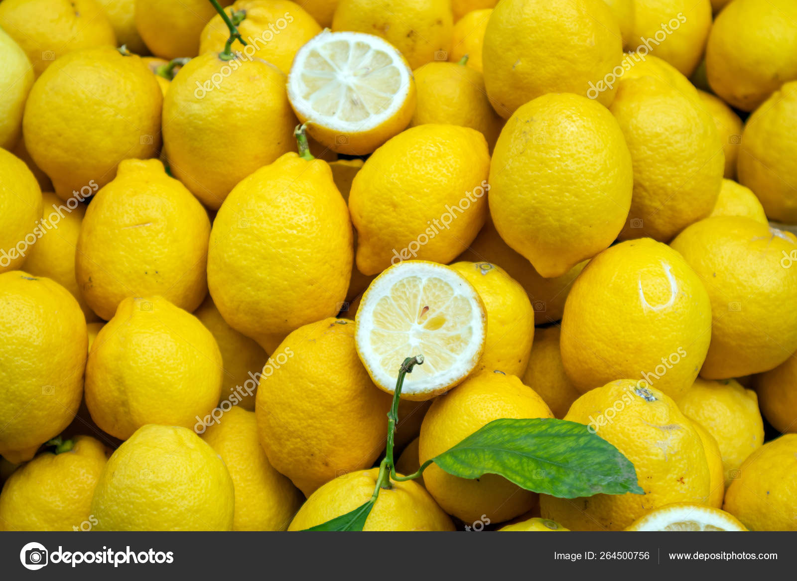 Whole lemons and cut background, texture. Closeup view Stock Photo by ...