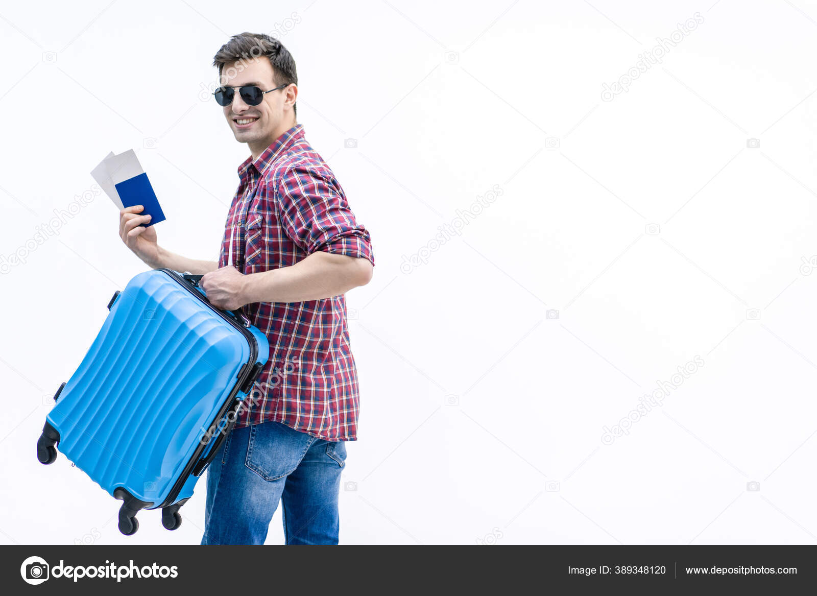 Excited young man ready for a trip, saying good-bye in the airport ...