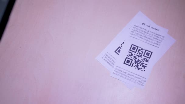 Smartphone scanning QR code in paper label on the orange package or ...