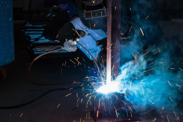 Welding skills training of welder with protective mask and welding ...