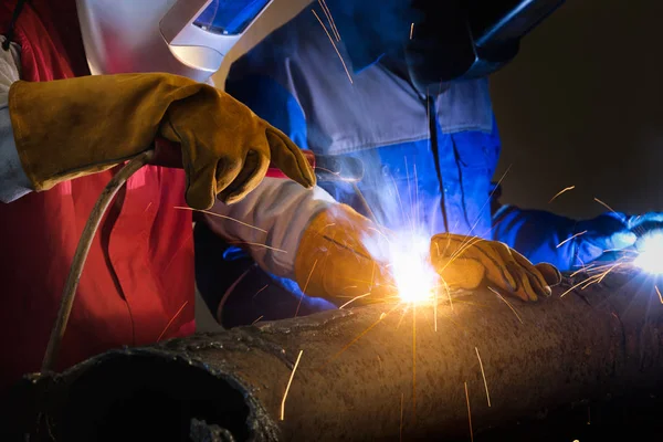 Welding skills training of welder with protective mask and welding ...