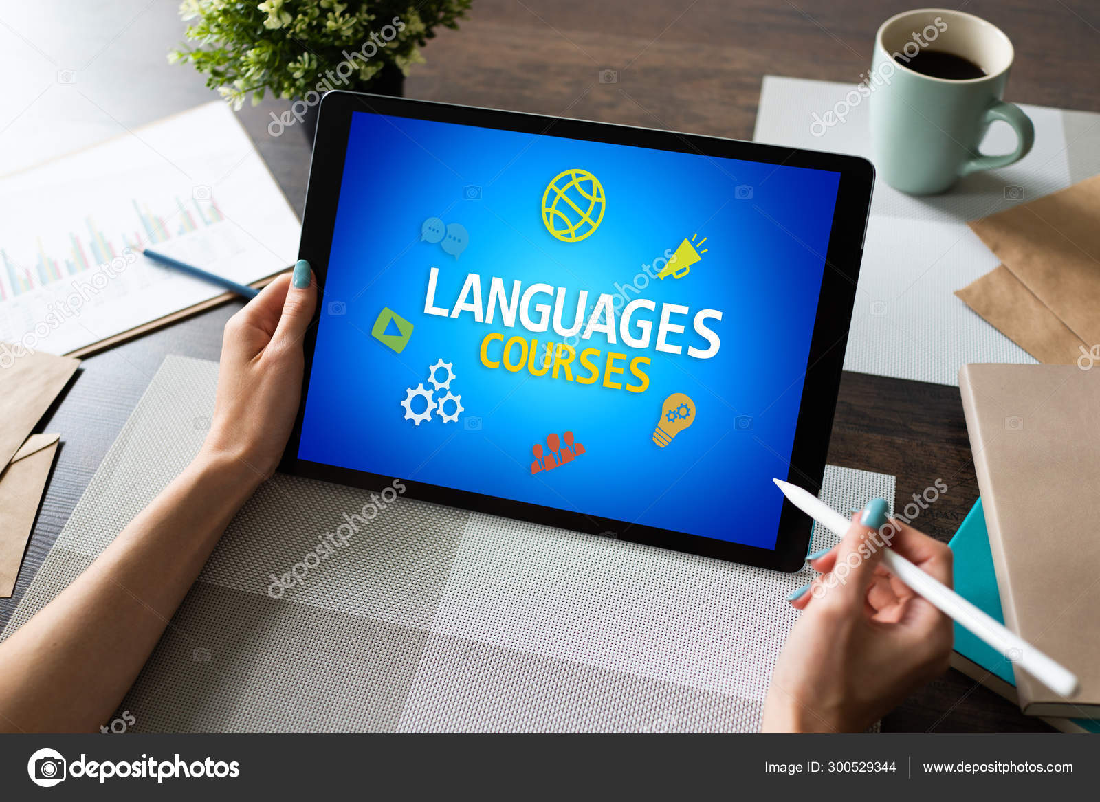 Tablet with languages courses text and icons on screen. English ...
