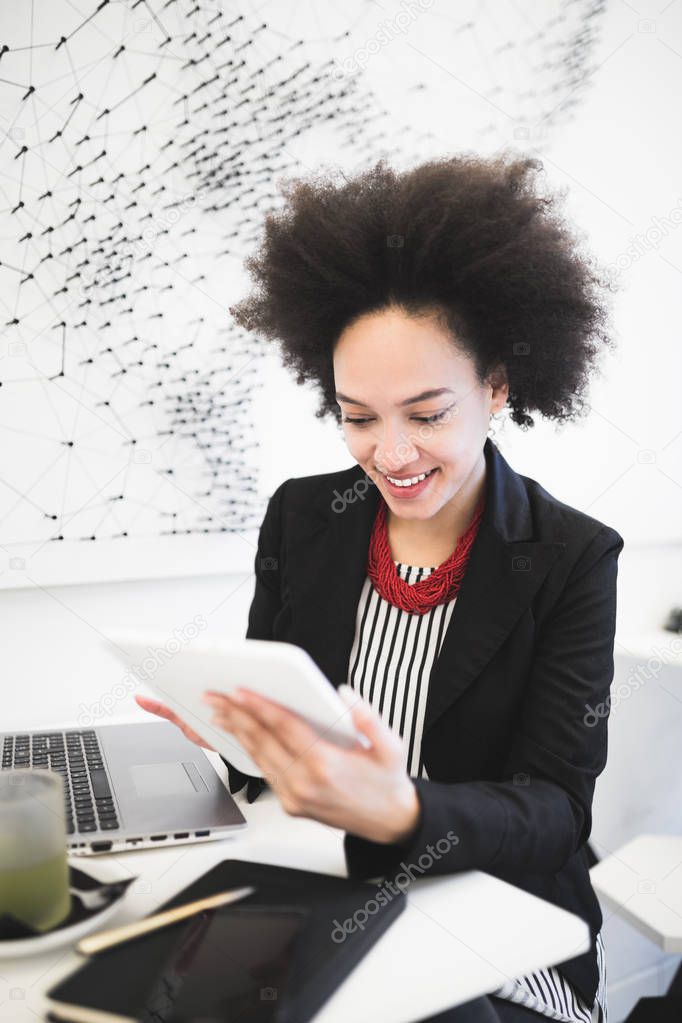 Mujer de negocios afroamericana linda confiada y sonriente sentada en una cafetería moderna y ...