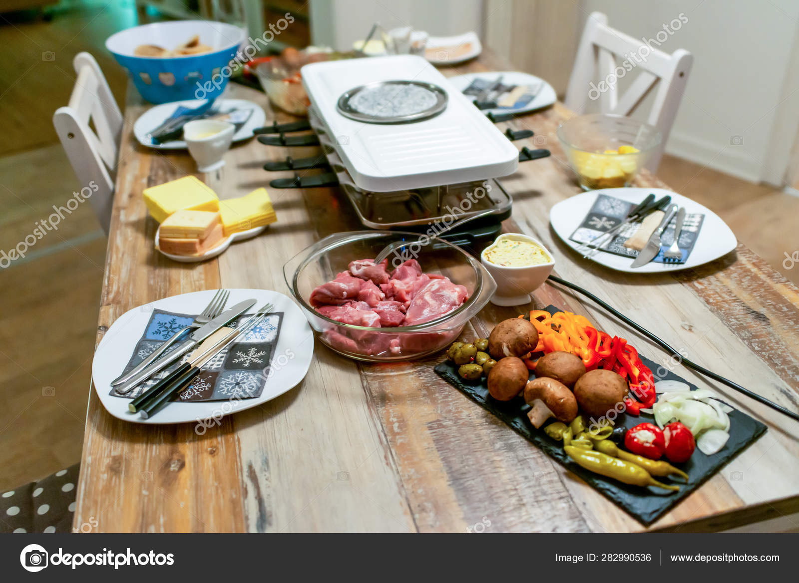 Swiss or Dutch raclette table filled with ingredients for a celebratory ...