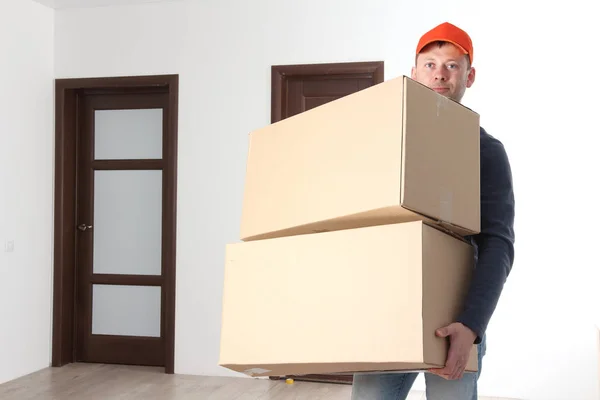 Delivery man with cardboard boxes. Shipping parcel. - Stock Image ...