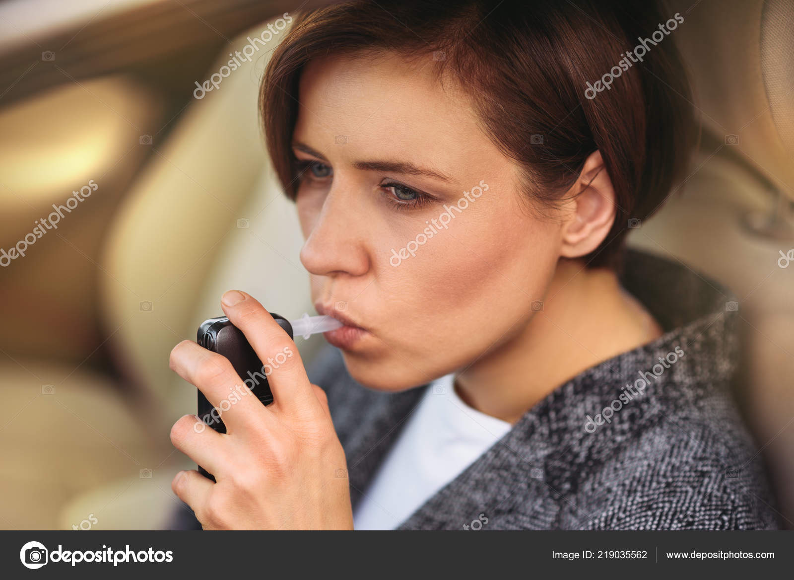 Woman using breath alcohol analyzer in the car Stock Photo by ...