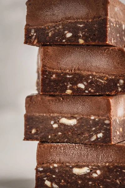 Stack of chocolate fudge bars on white background. Clean eating concept ...