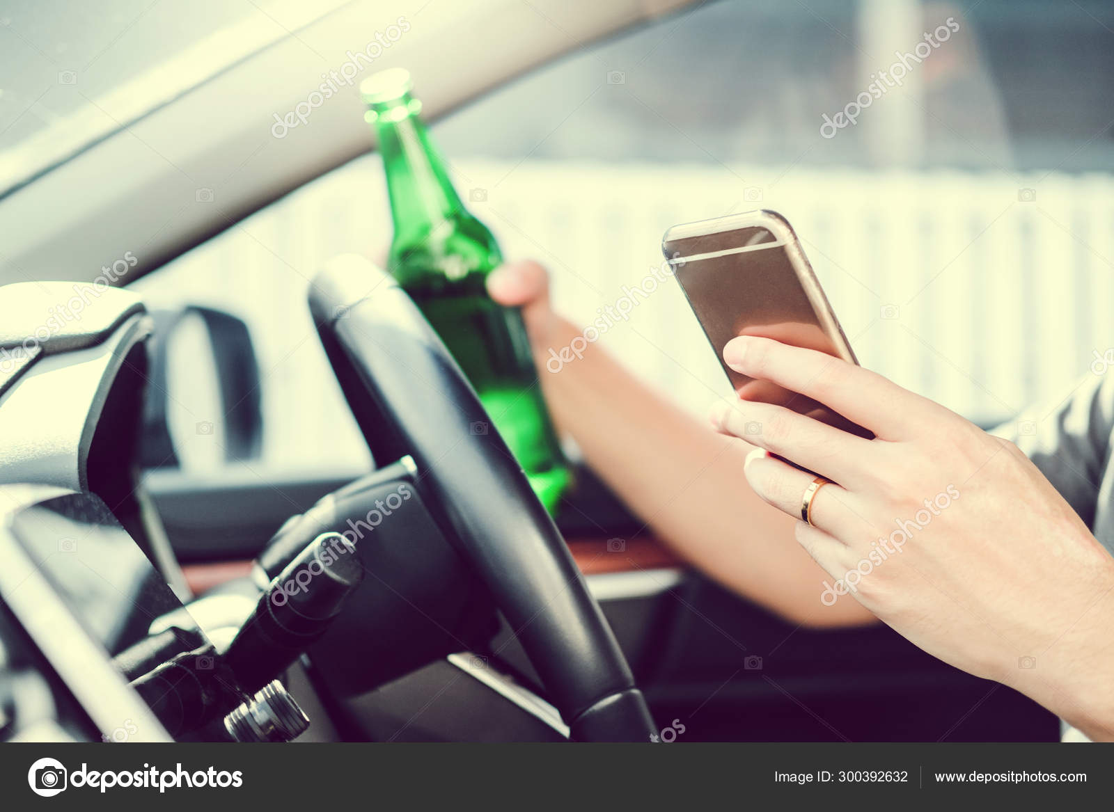 Drunk man driving a car on the road holding bottle beer Dangerou ...